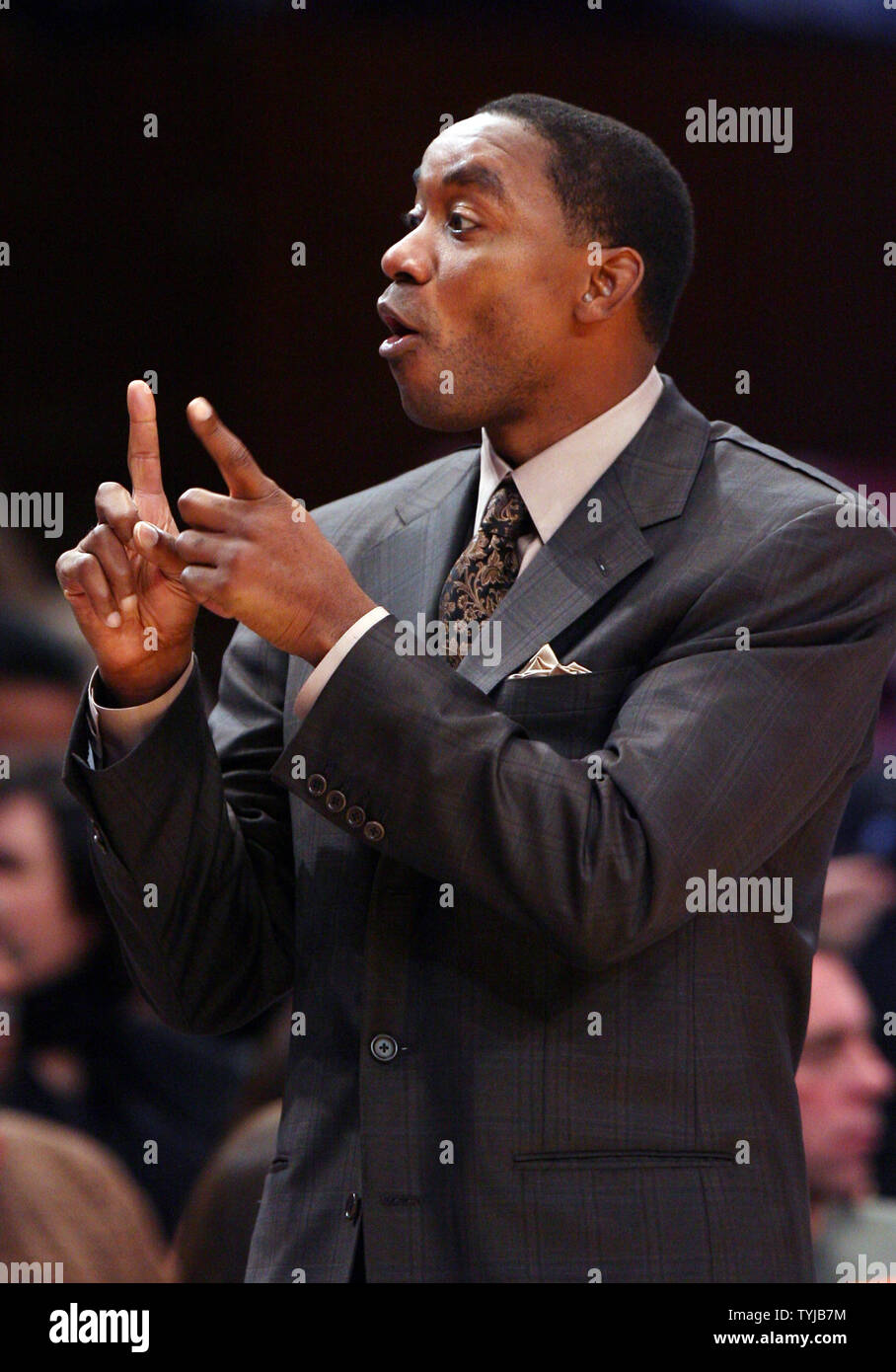 New York Knicks head coach Isiah Thomas oints his fingers in the first ...