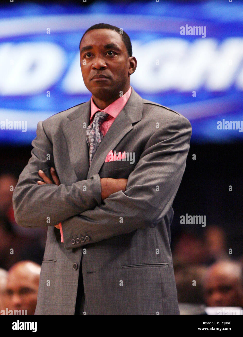 New York Knicks head coach Isiah Thomas folds his arms while watching ...