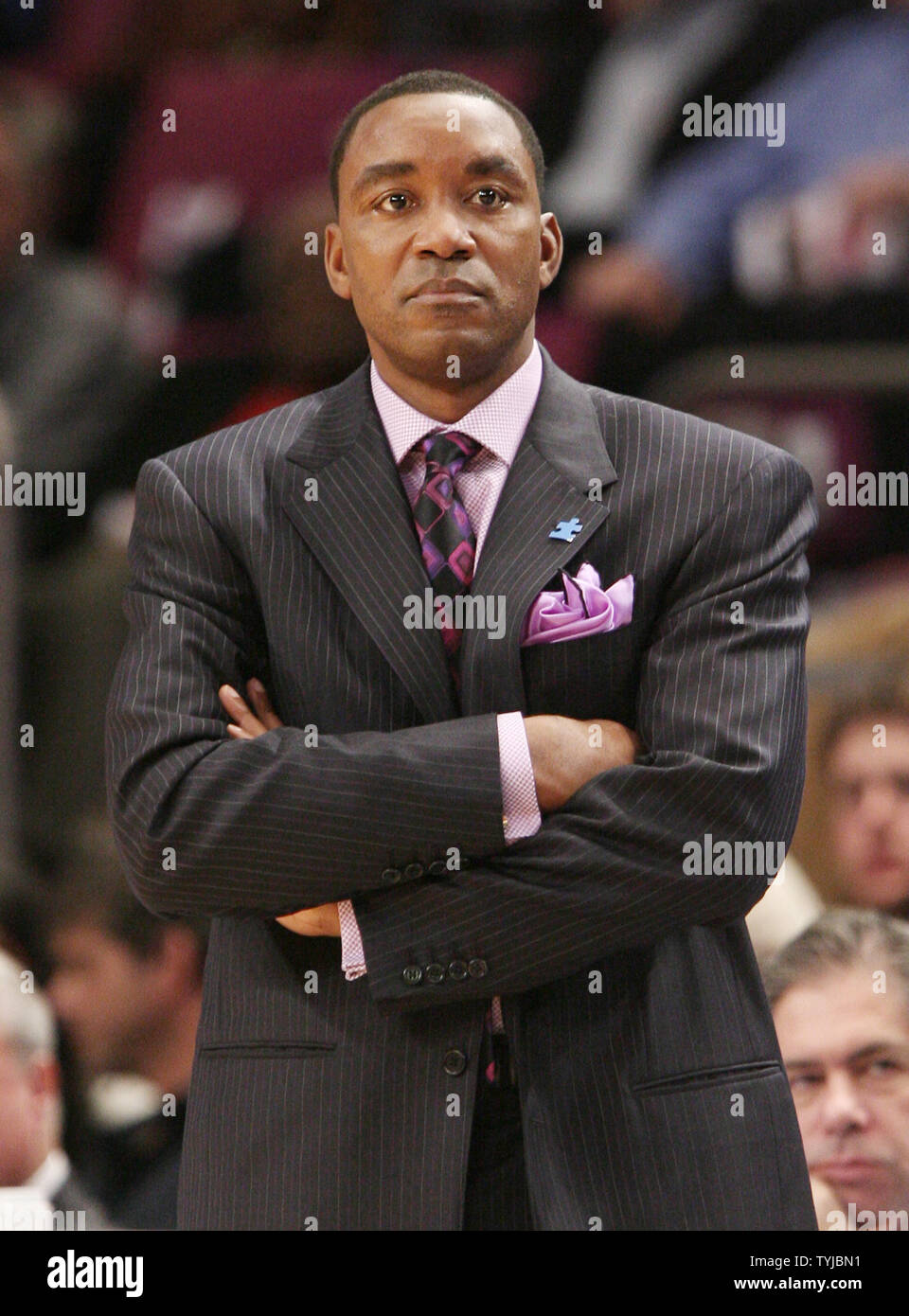 New York Knicks head coach Isiah Thomas folds his arms while watching ...