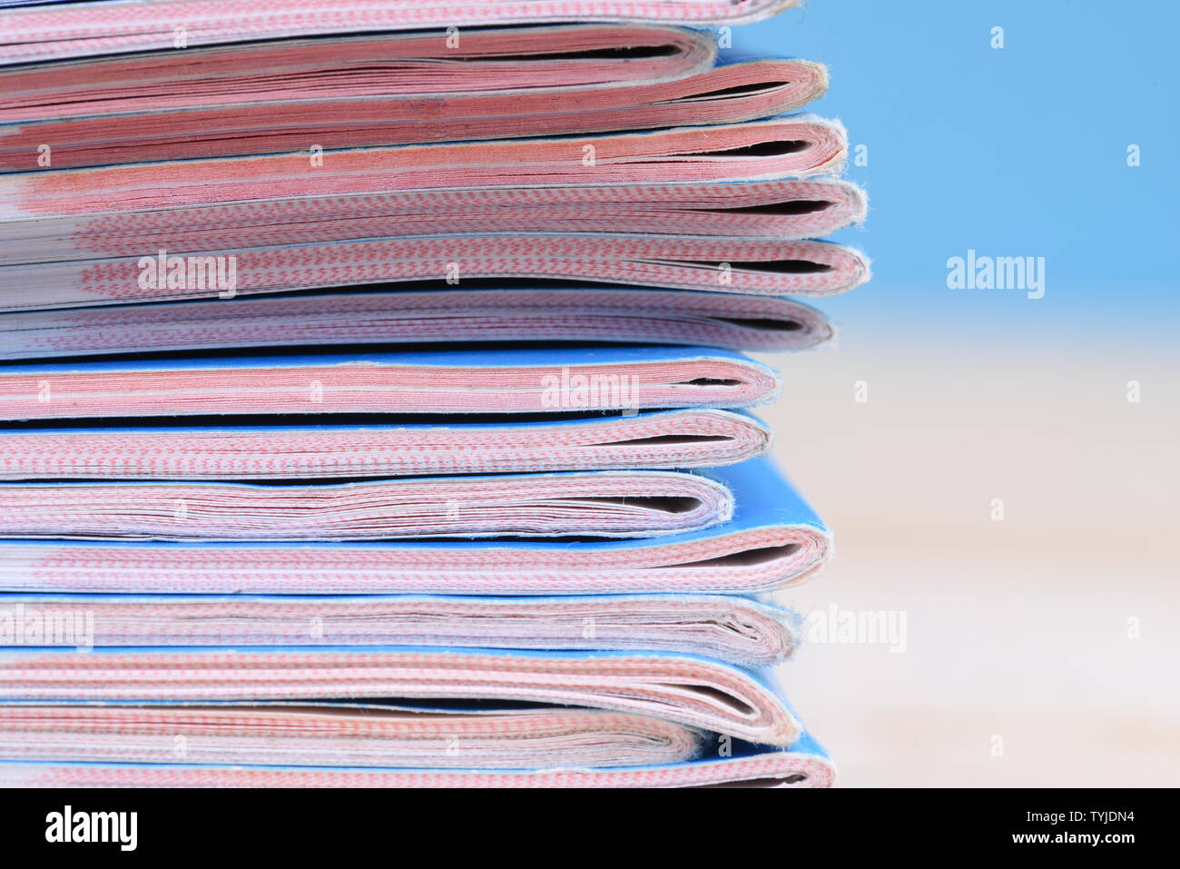 Stack of magazines on blurred background Stock Photo - Alamy