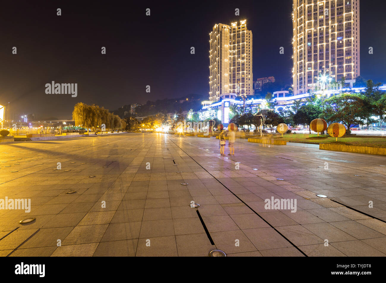 Empty floor and illuminated skyscraper Stock Photo - Alamy