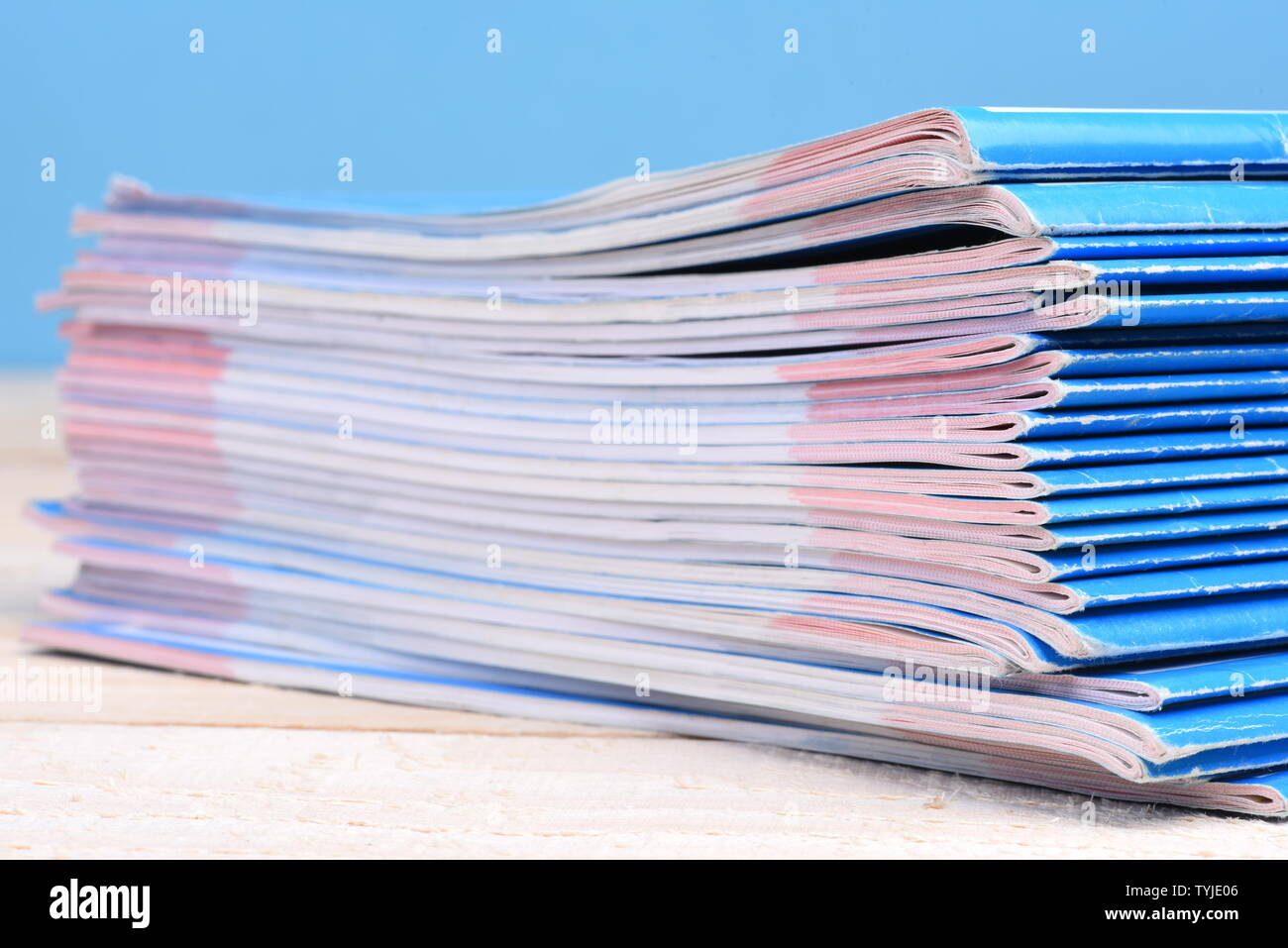 Stack of magazines on blurred background Stock Photo - Alamy