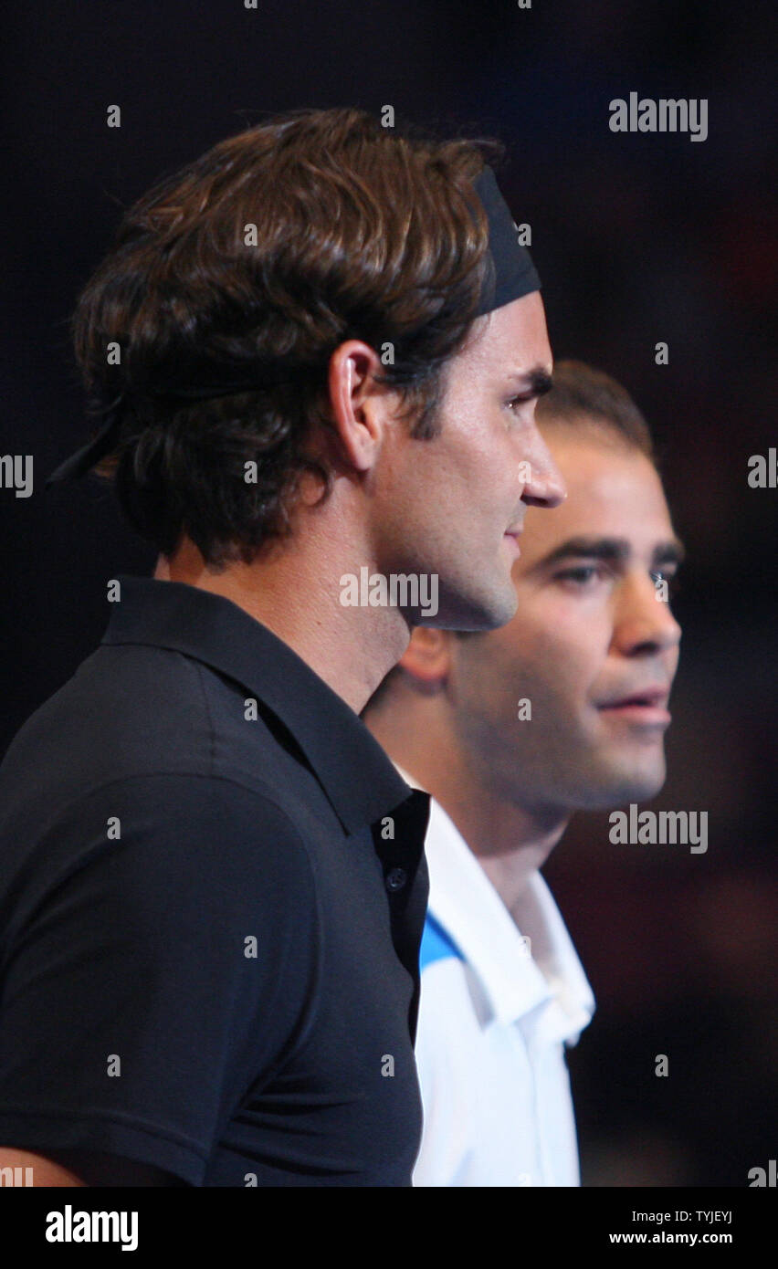 Roger Federer and Pete Sampras stand on the court before playing each ...