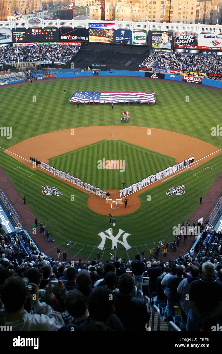 New York Yankees and Toronto Blue Jays players stand on the first and ...