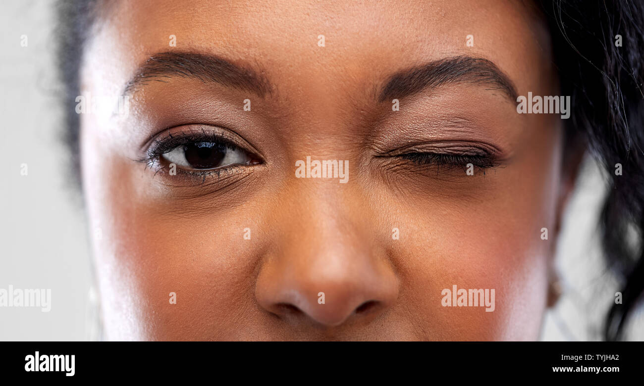 close up of african american woman winking one eye Stock Photo - Alamy