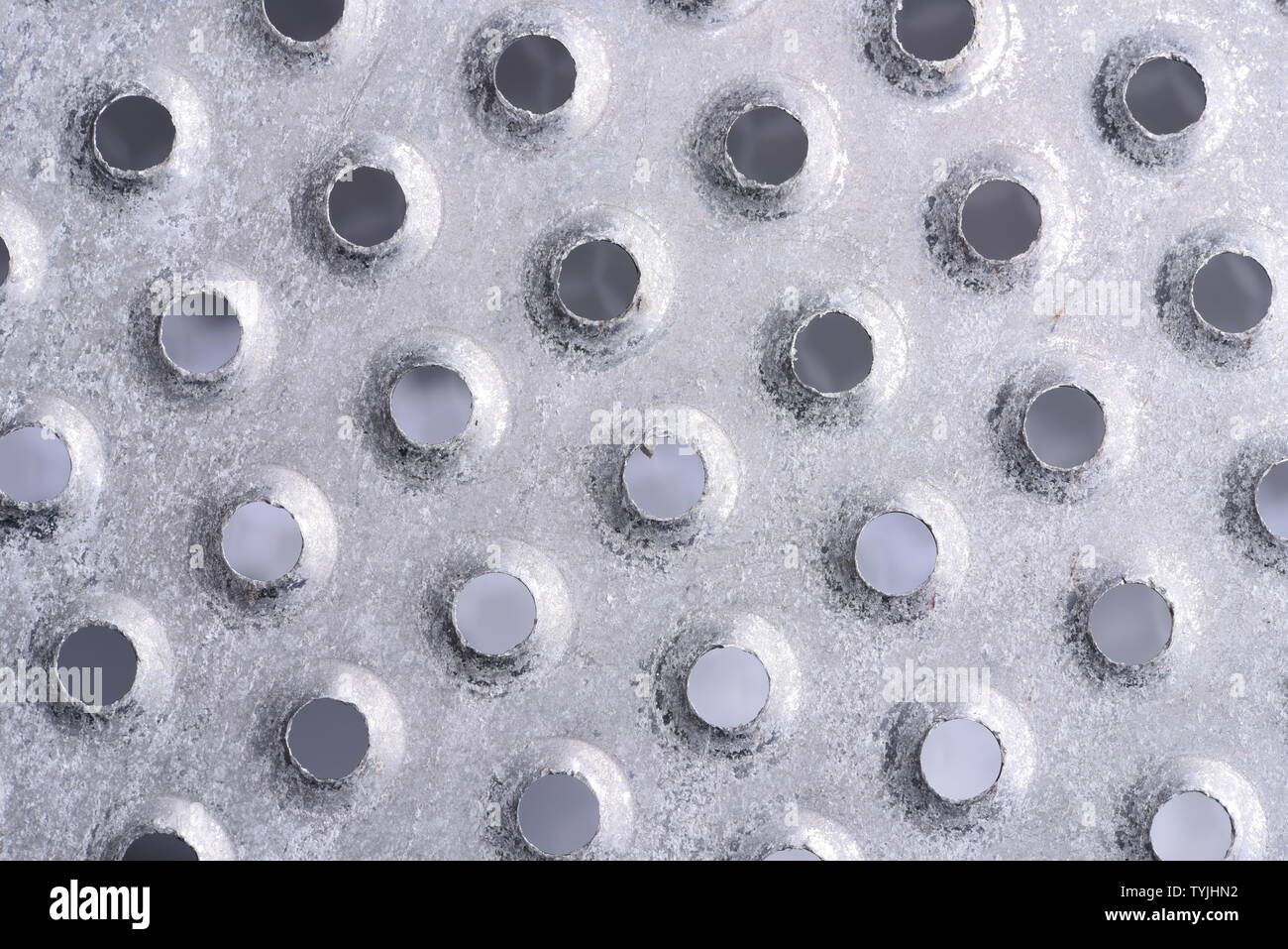 Metal background with circles holes closeup Stock Photo - Alamy