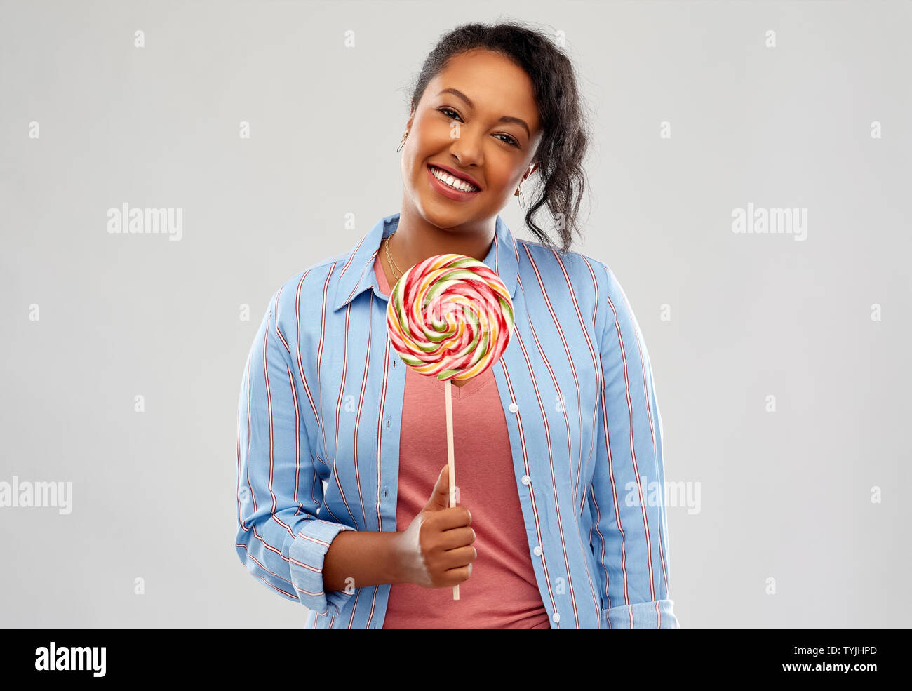 happy african american woman with big lollipop Stock Photo - Alamy