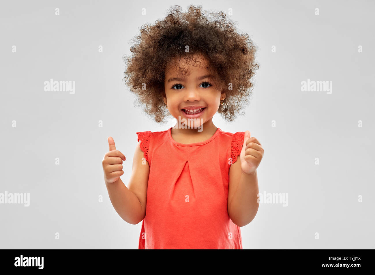 little african american girl showing thumbs up Stock Photo - Alamy