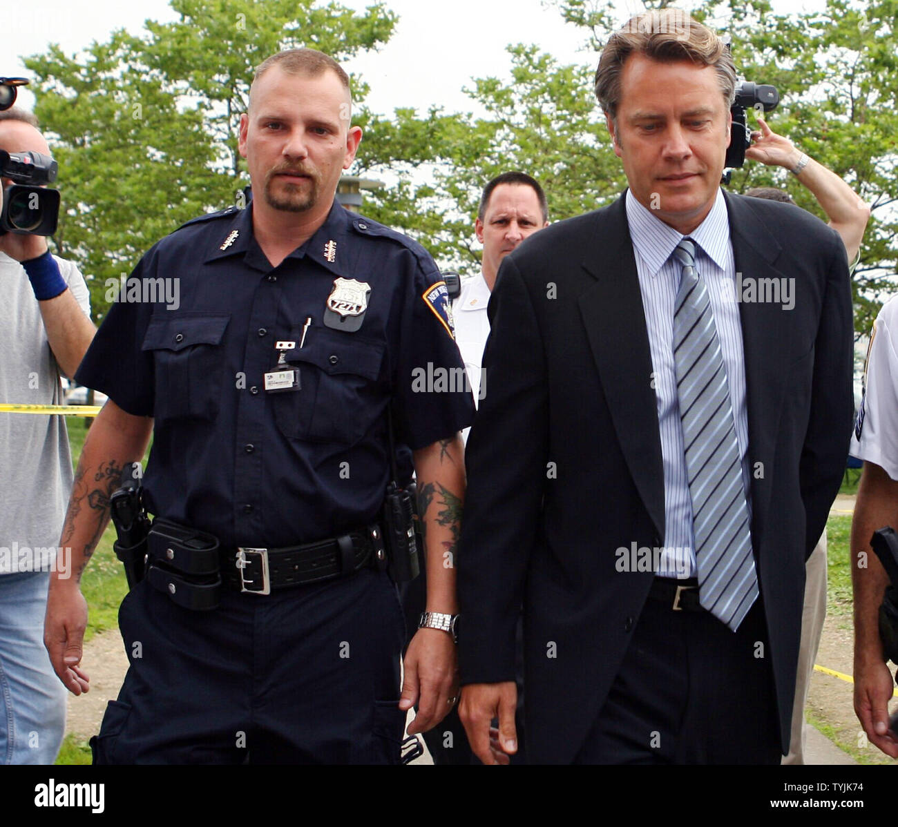 Peter Cook (R) arrives for court in his divorce trail against Christie ...