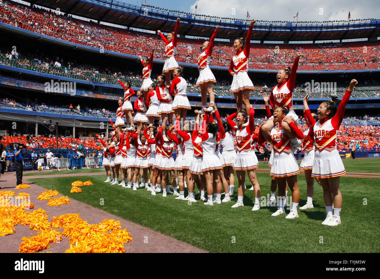 A Japanese cheer leading squad finishes their routine on the field ...