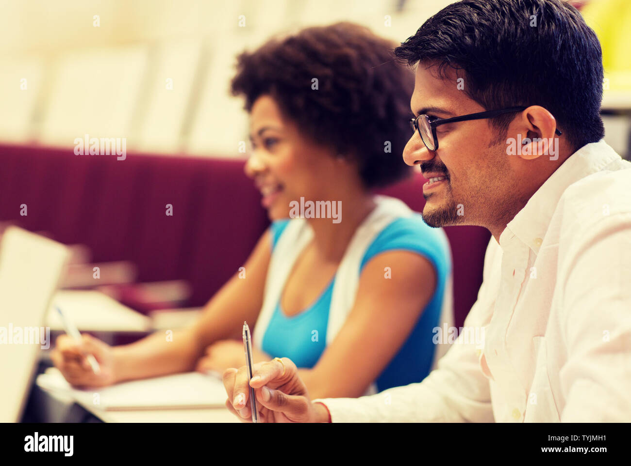 group of students with notebooks in lecture hall Stock Photo - Alamy