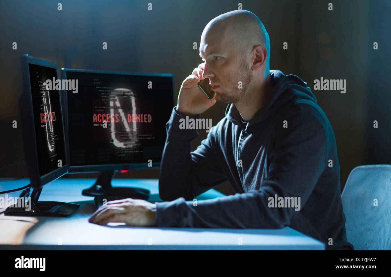hacker with no access on computer calls on cell Stock Photo - Alamy