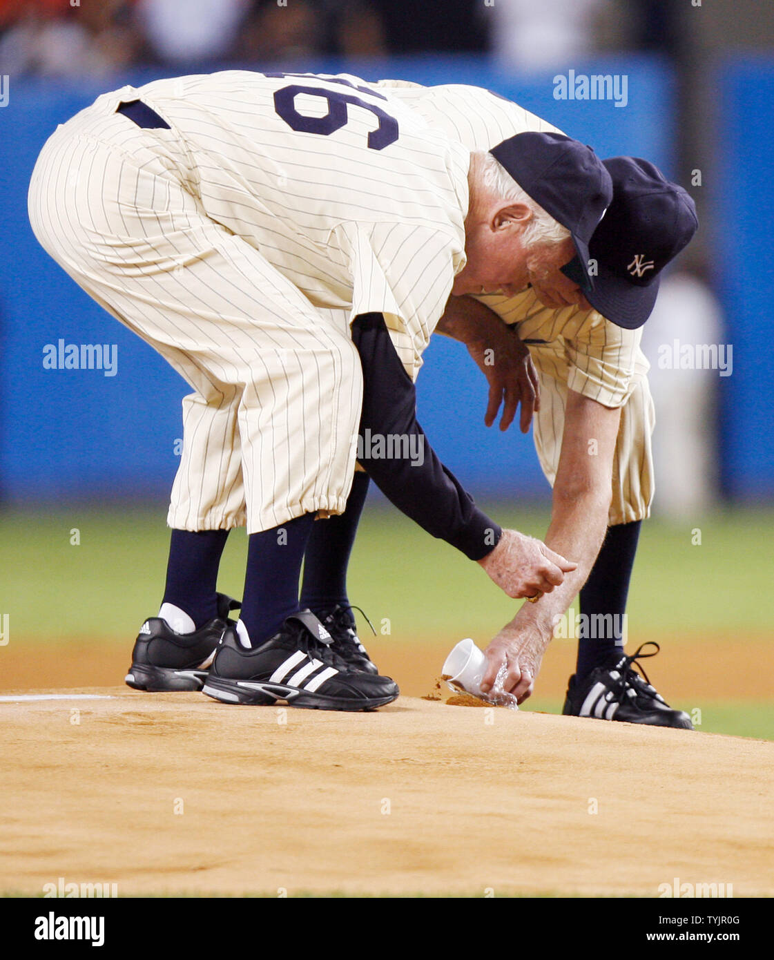 Don Larsen and Whitey Ford grab some dirt from the pitchers mound and ...
