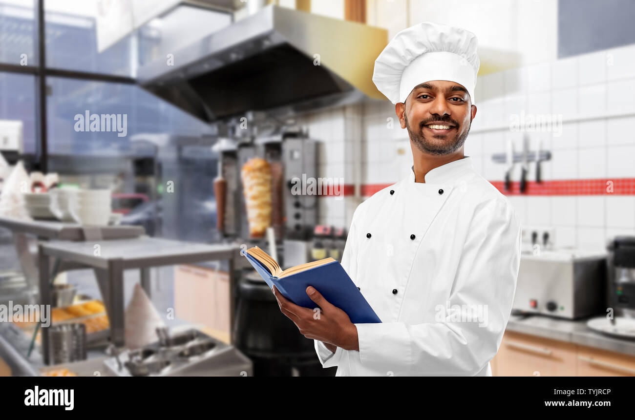happy indian chef with cookbook at kebab shop Stock Photo - Alamy