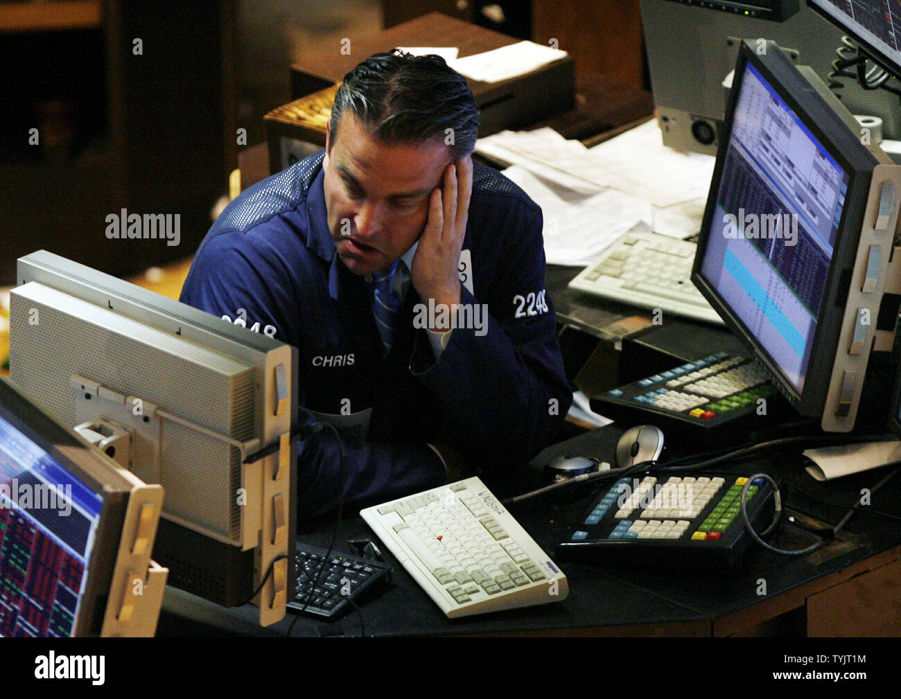A Wall Street employee reacts after the ringing of the closing bell on ...