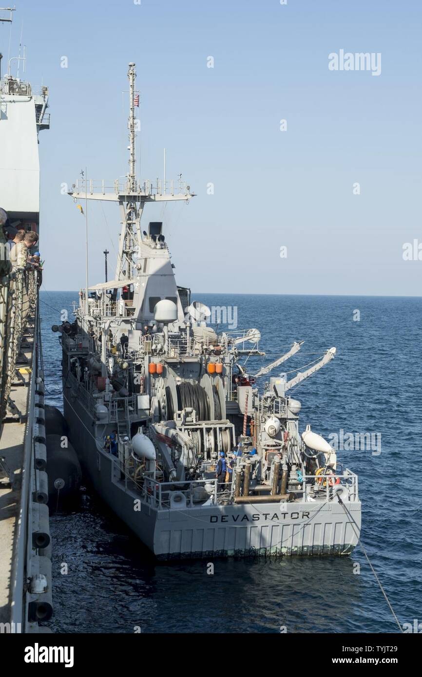 The mine countermeasure (MCM) ship USS Devastator (MCM 6) rafts with ...