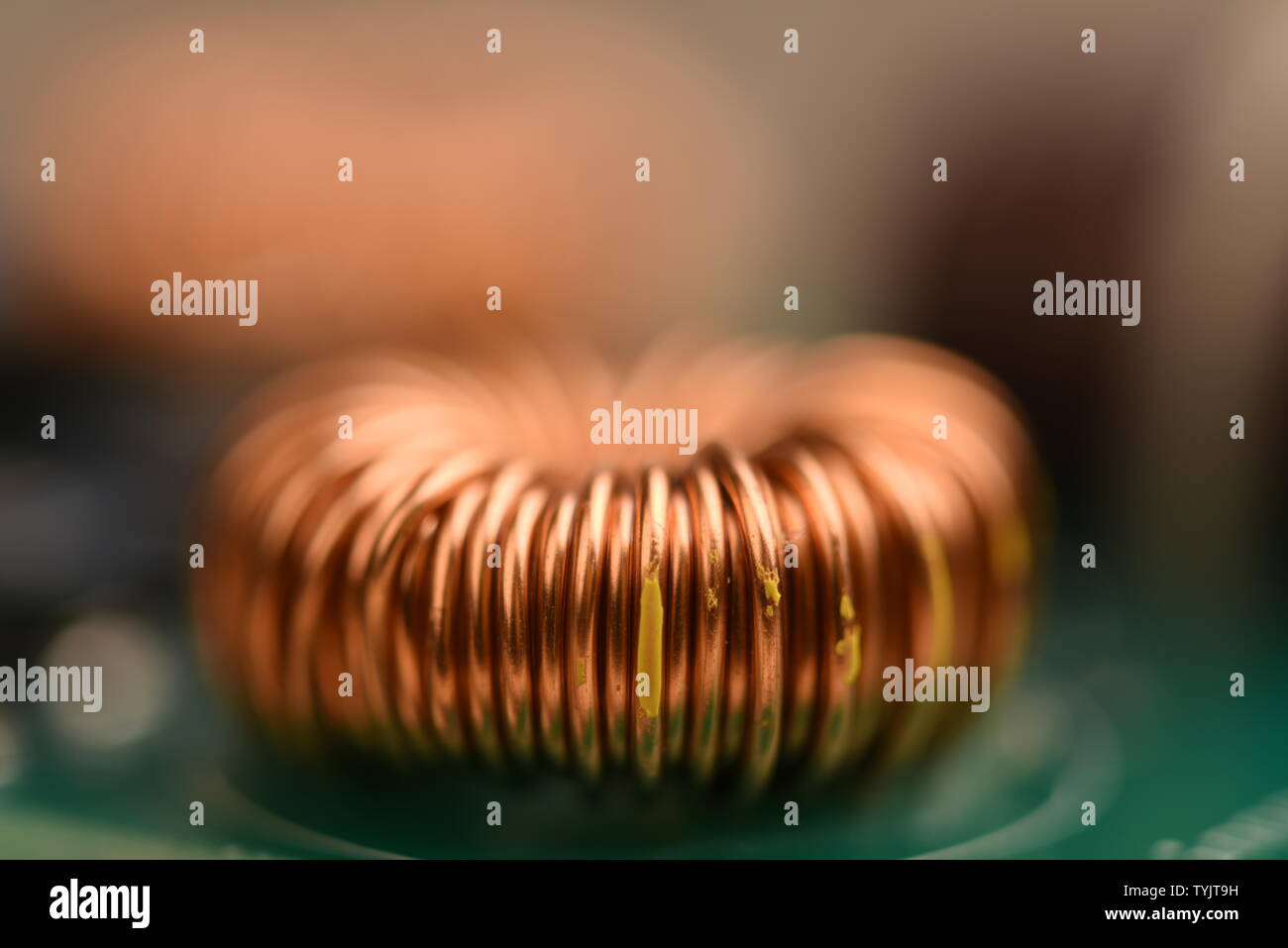 Macro of single copper coil on motherboard Stock Photo - Alamy
