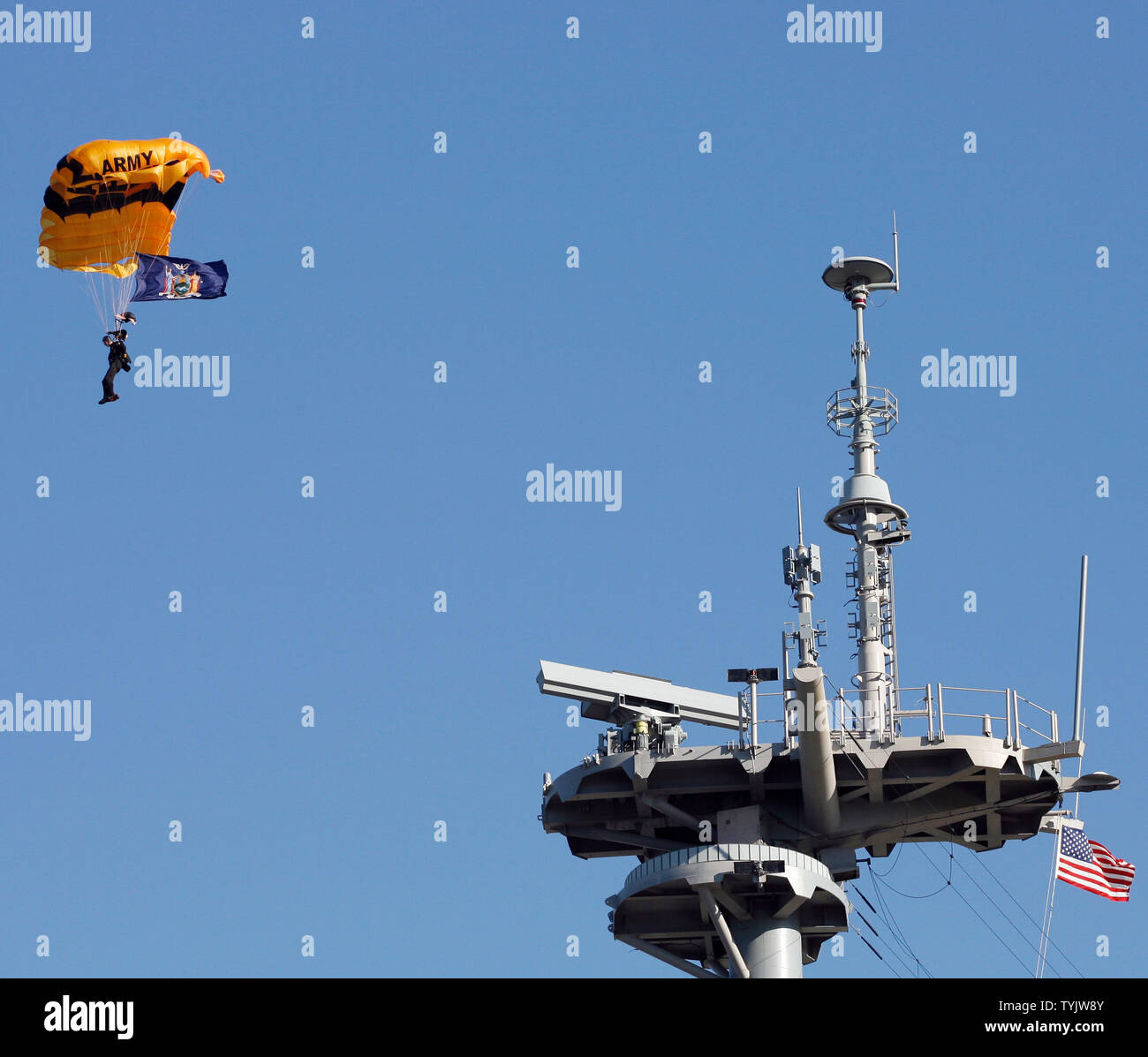 A parachute team lands on an air craft carrier before President George ...