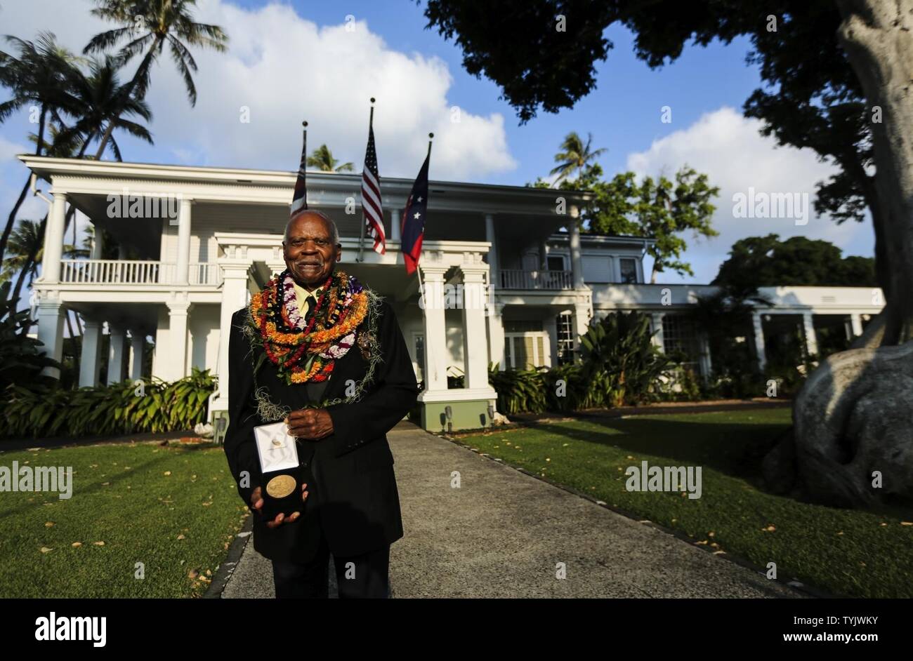 Dr. Ernest James Harris, Jr. stands with his Congressional Gold Medal ...