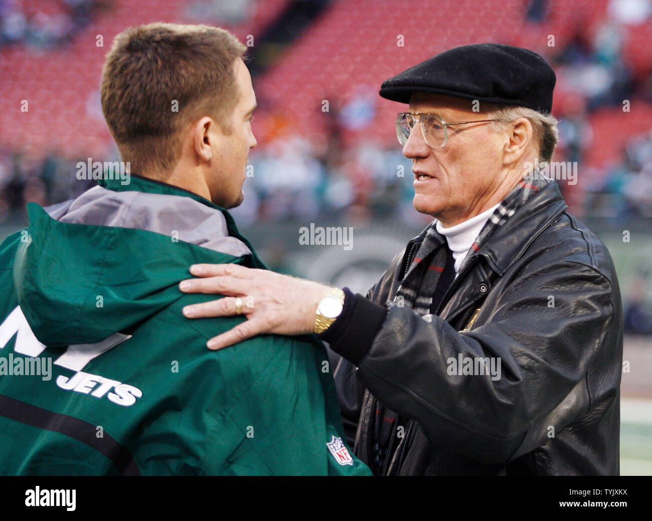 Marty Schottenheimer puts his hands on the shoulders of Brian ...