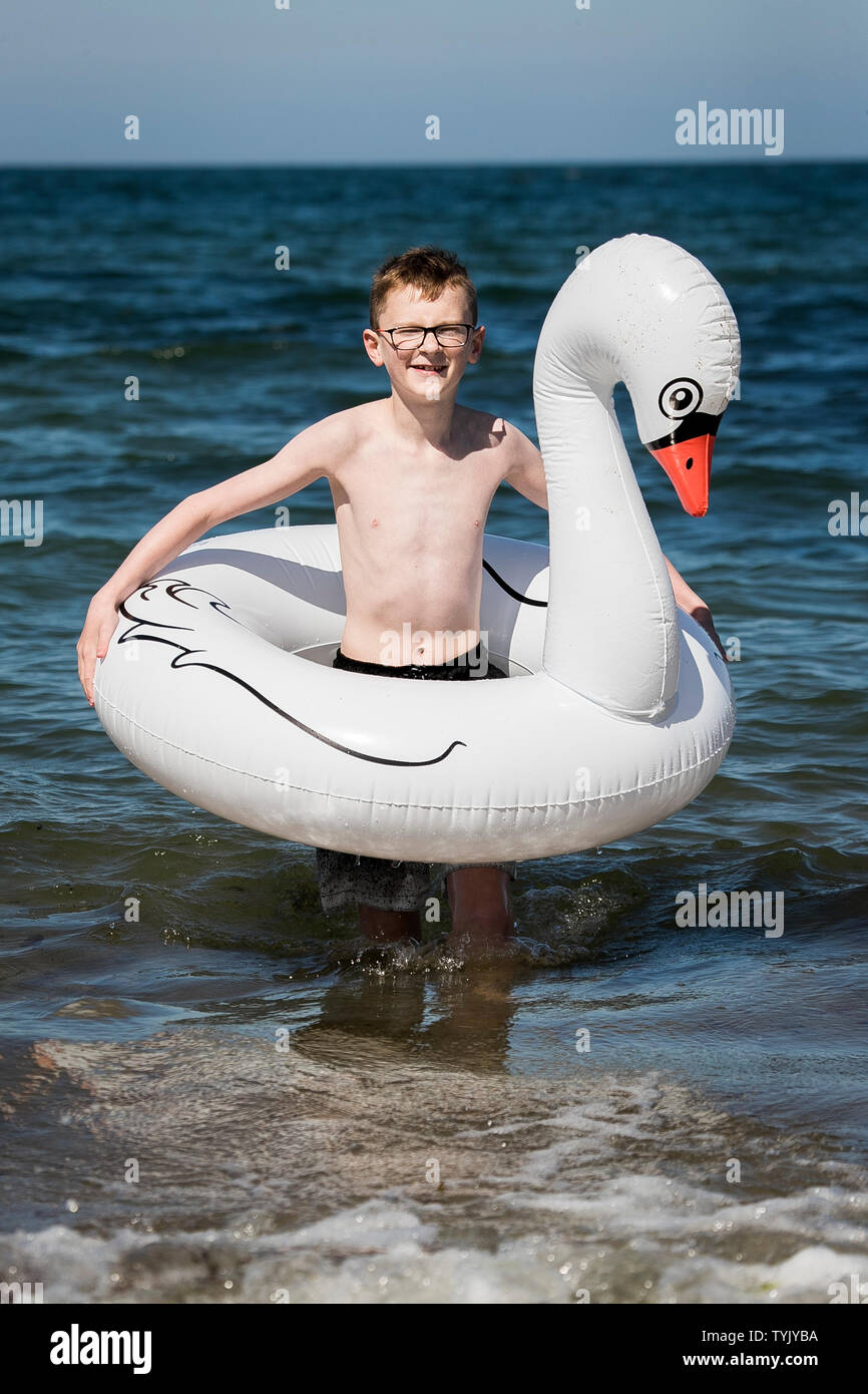 Carter Graham, 11, enjoying the water at Helens Bay beach in Northern ...