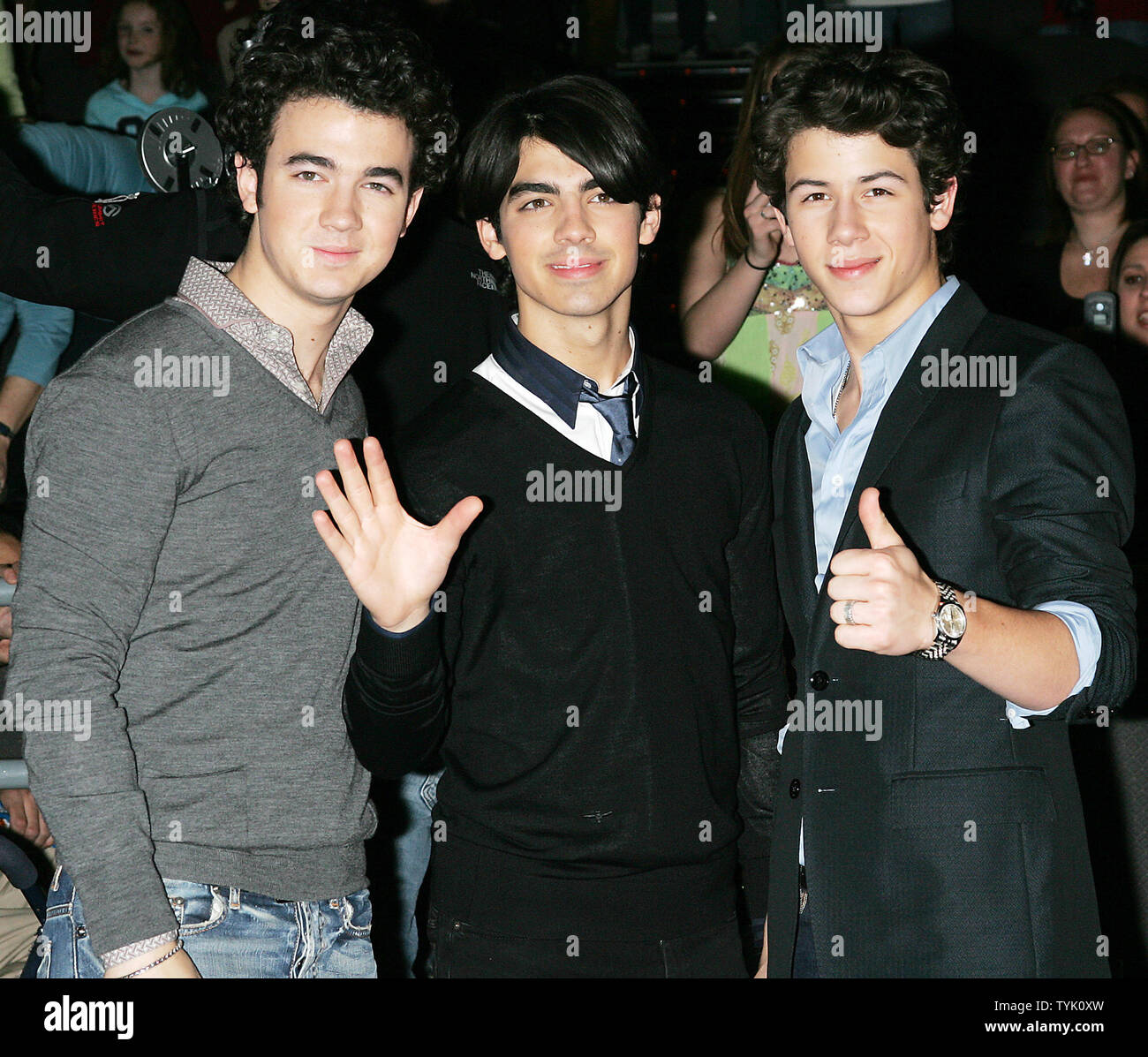 The Jonas Brothers (L-R) Kevin, Joe and Nick surprise fans at the AMC ...