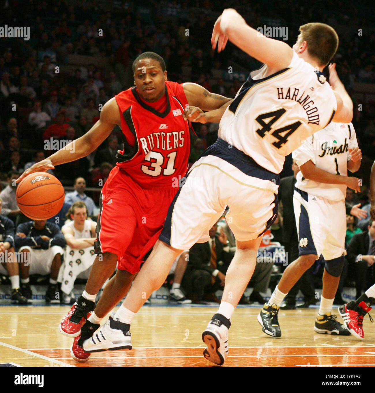 Rutgers' Mike Coburn (L) dribbles around Luke Harangody of Notre Dame ...