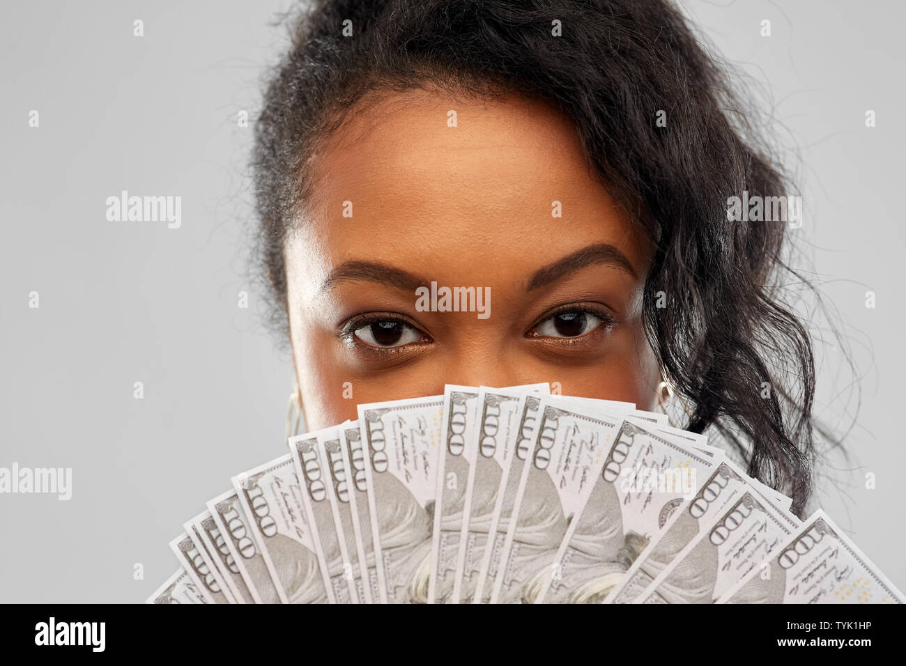 african american woman hiding face behind money Stock Photo - Alamy