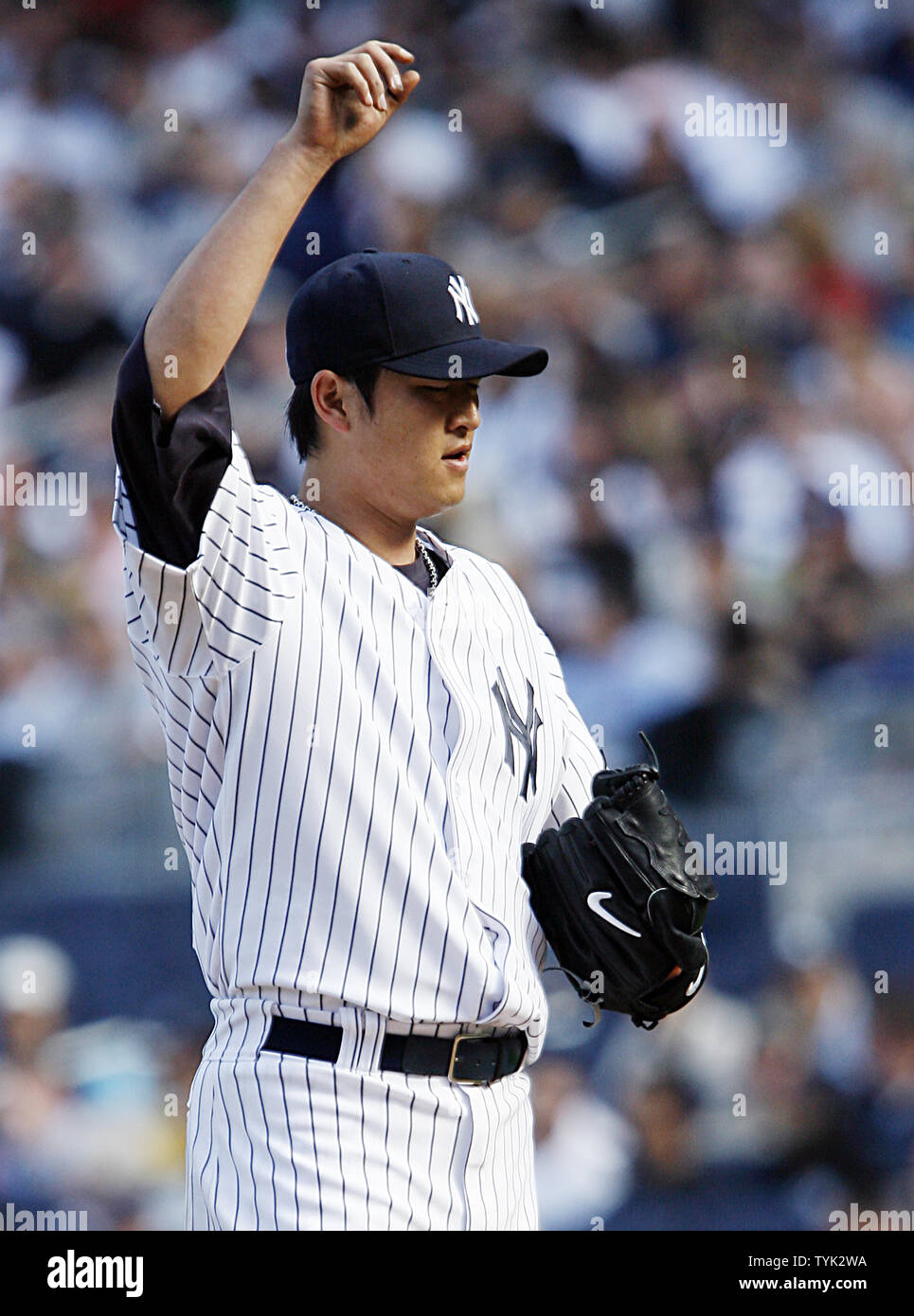 New York Yankees starting pitcher Chien-Ming Wang stretches his arm in ...