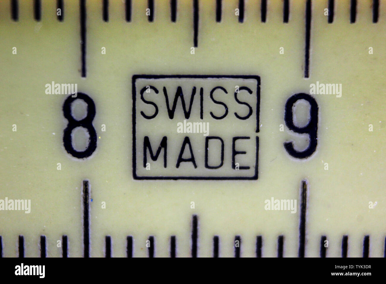 Macro closeup of swiss made seal printed on vintage plastic yellow ...