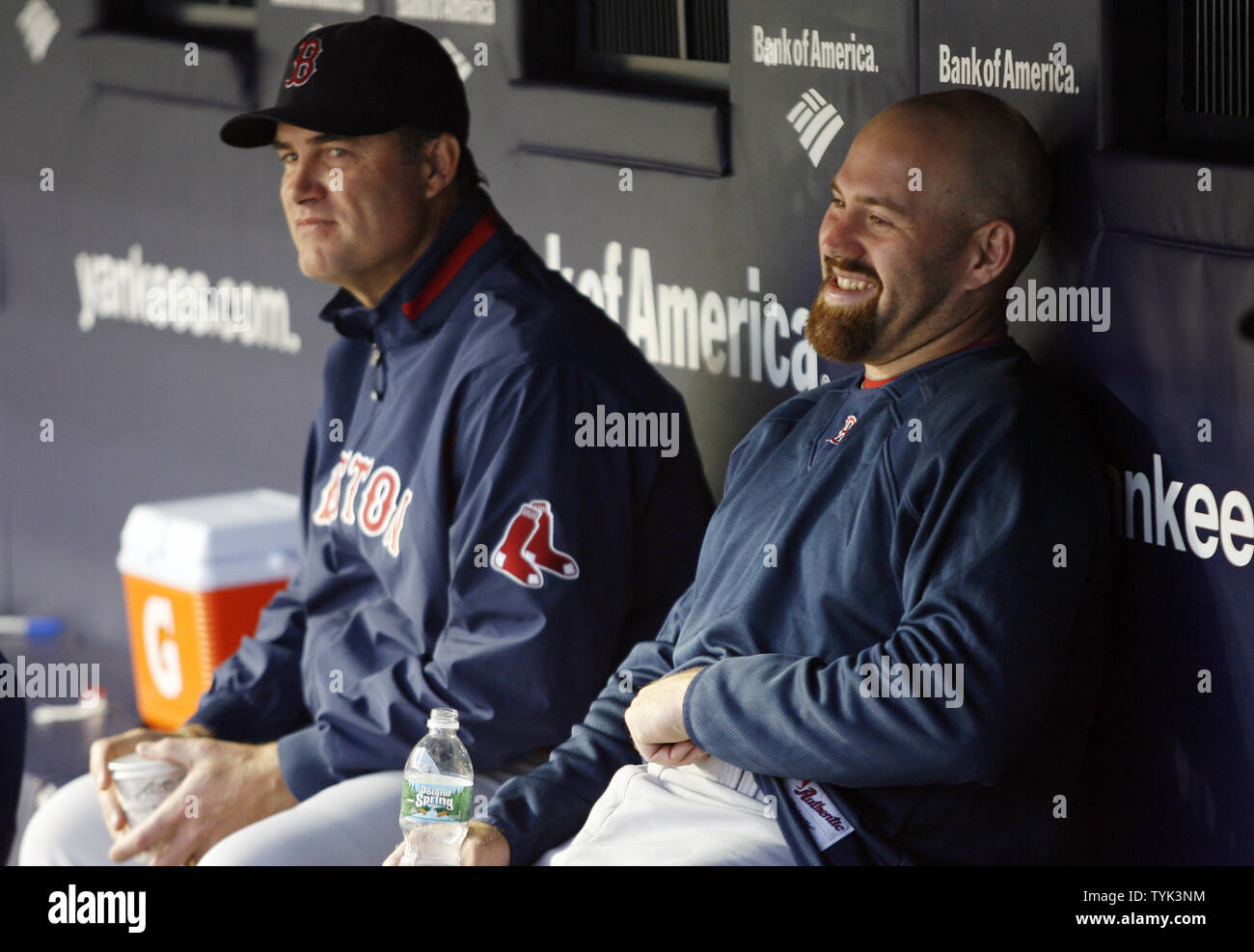 Boston Red Sox Kevin Youkilis (R) reacts in the dugout during a rain ...