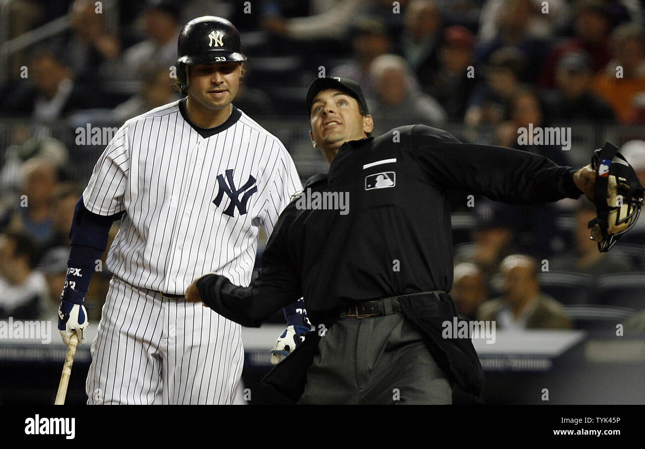 Home plate umpire James Hoye throws New York Yankees Nick Swisher out ...