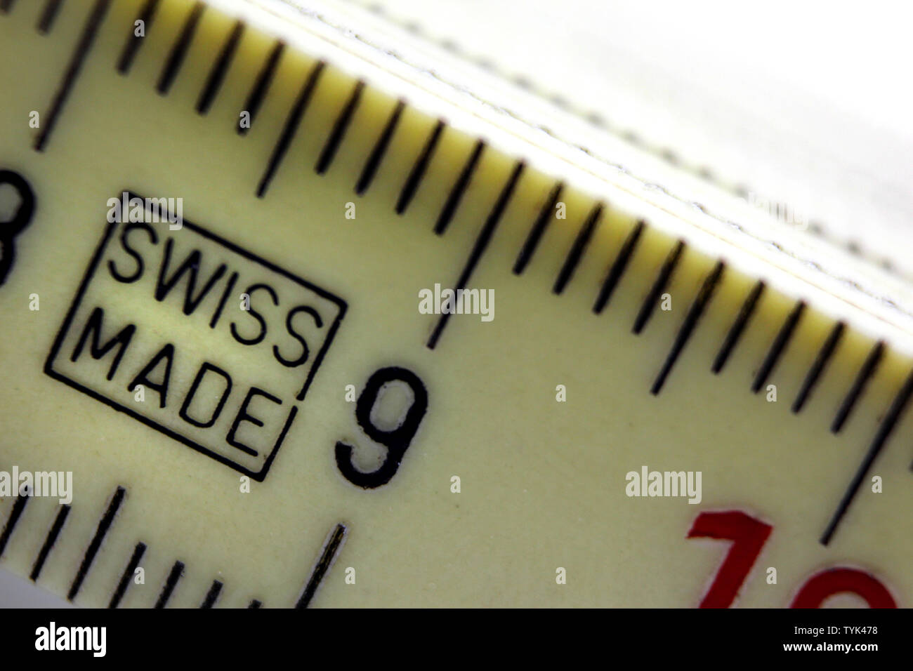Macro closeup of swiss made seal printed on vintage plastic yellow ...
