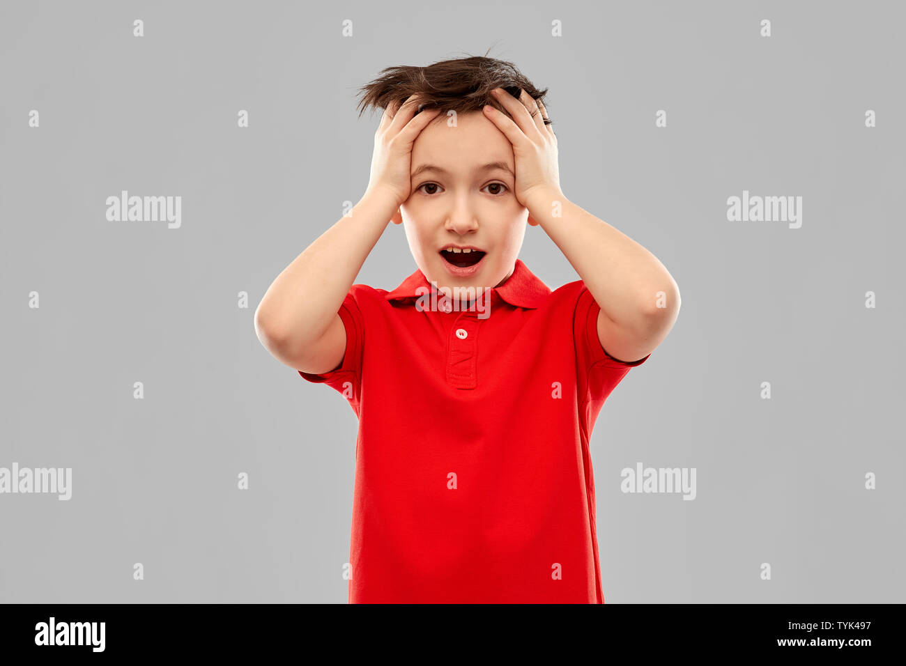 Boy touching his head hi-res stock photography and images - Alamy