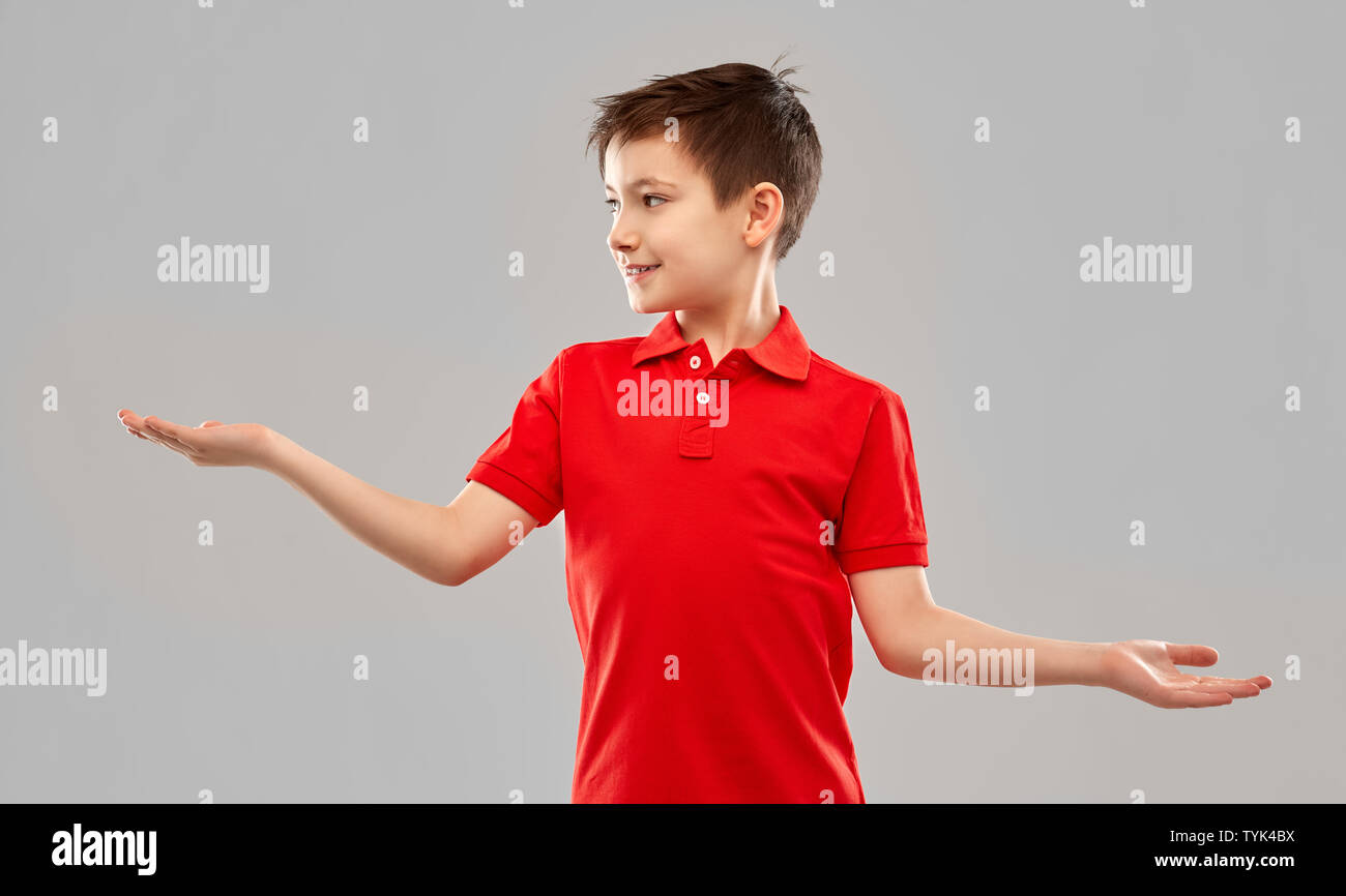 smiling boy holding something on empty hands Stock Photo - Alamy