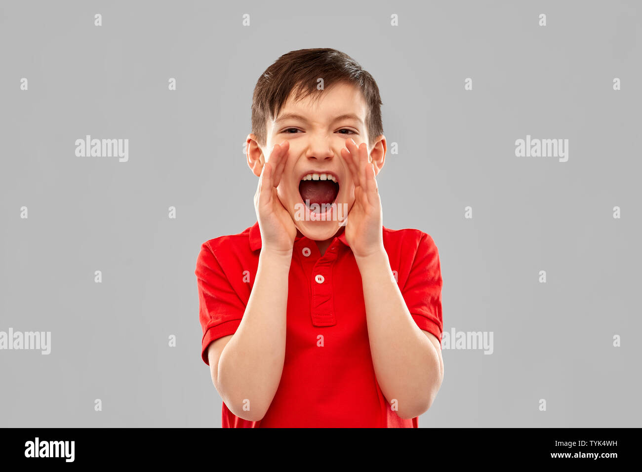 angry little boy in red polo t-shirt screaming Stock Photo - Alamy