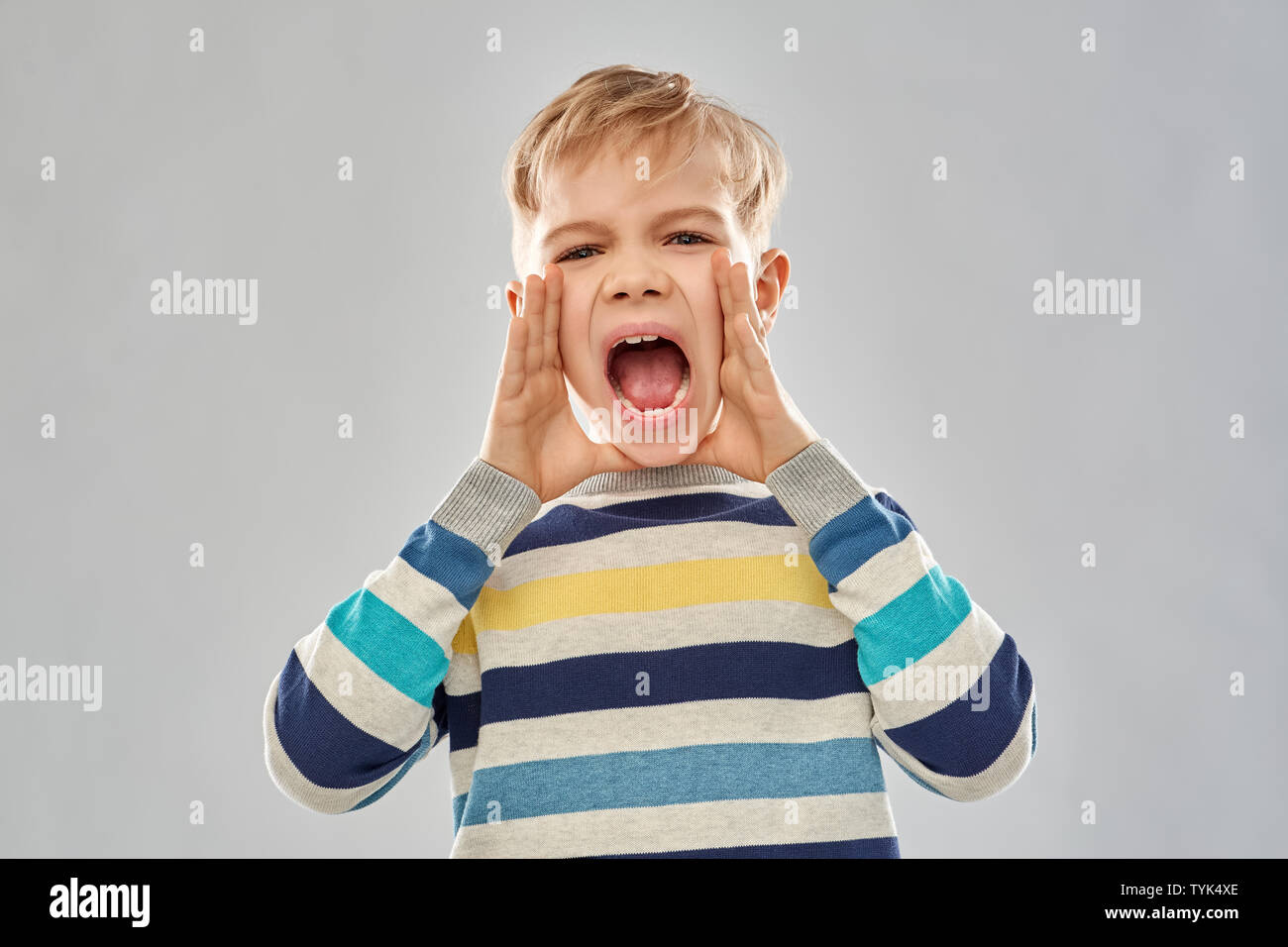 angry little boy in striped pullover screaming Stock Photo - Alamy