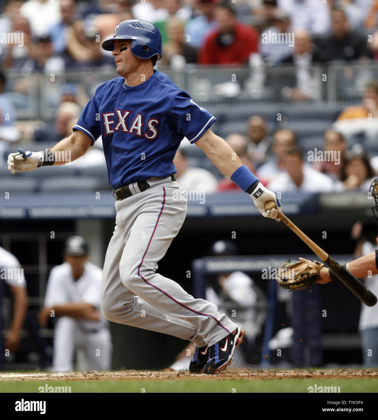 Texas Rangers Michael Young hits an infield single in the third inning ...
