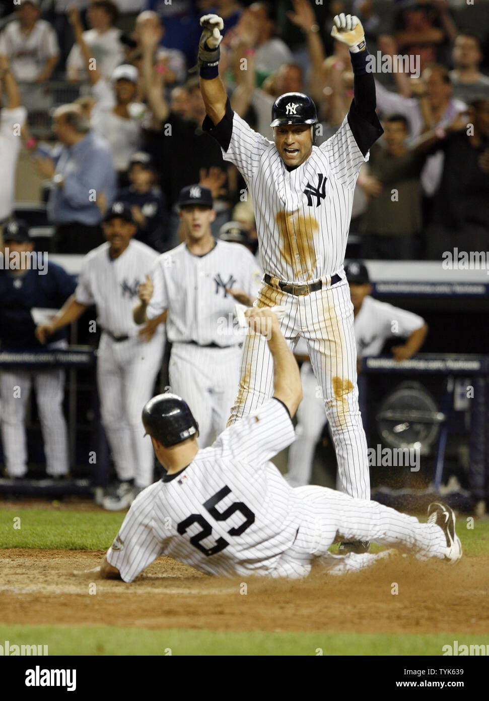 New York Yankees Derek Jeter reacts as Mark Teixeira slides in with the ...