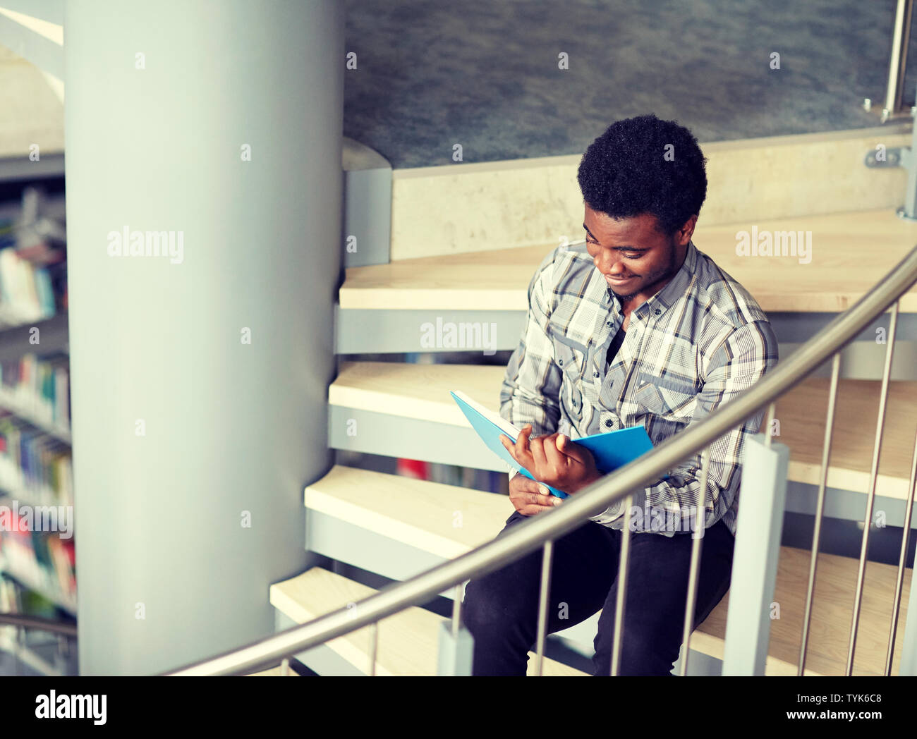 african student boy or man reading book at library Stock Photo - Alamy