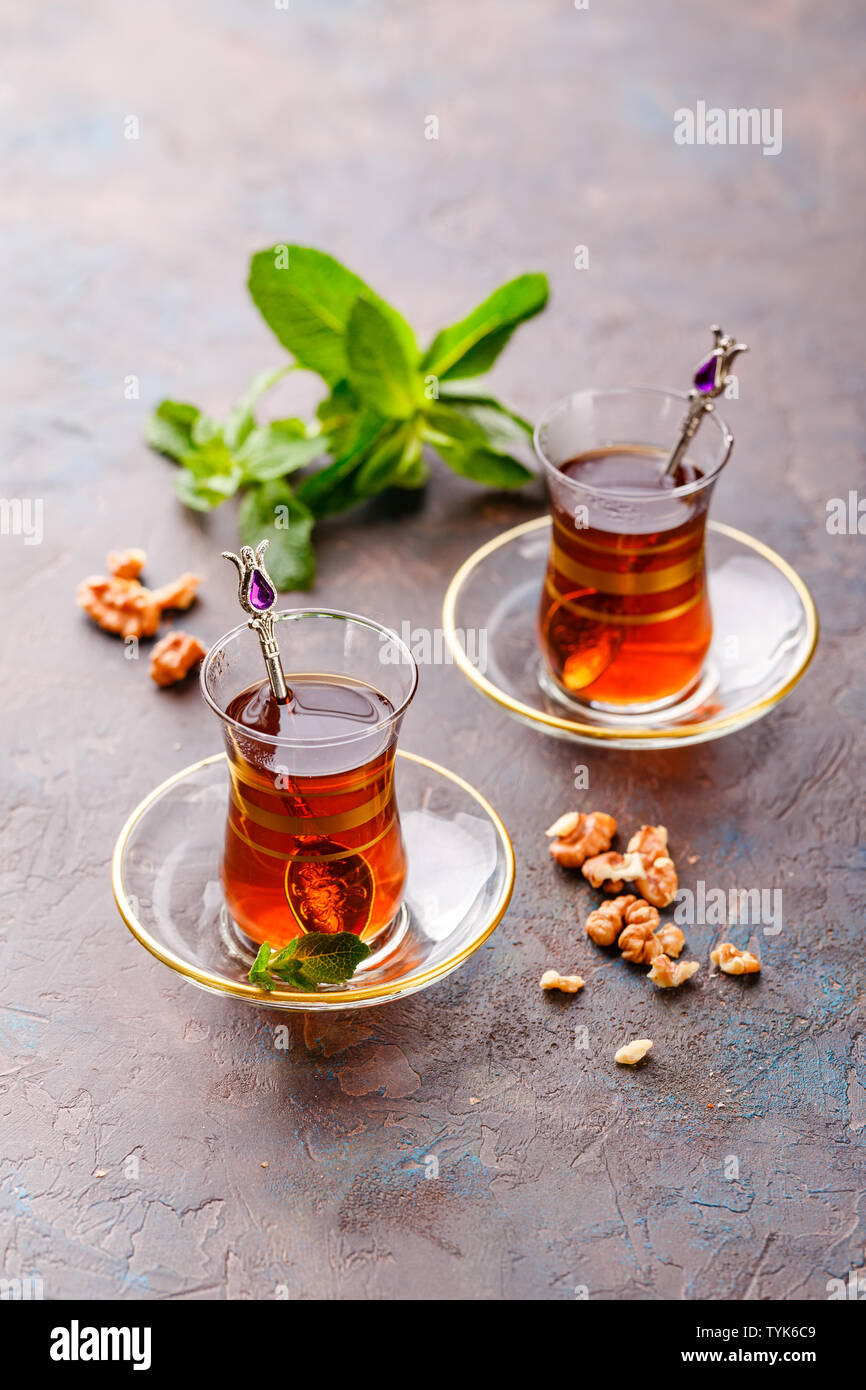 Traditional Turkish arabic dessert and a glass of tea with mint and ...