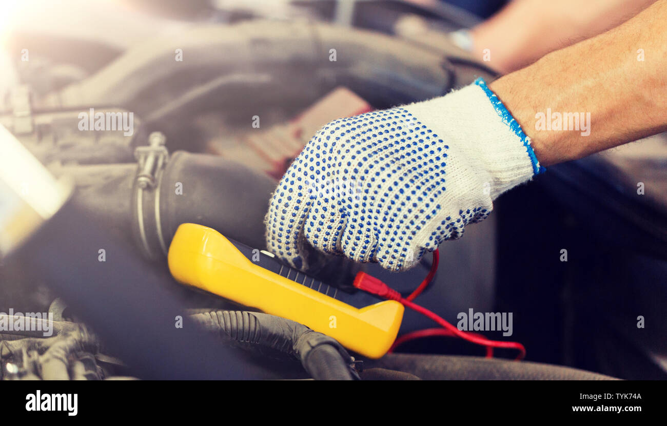 auto mechanic man with multimeter testing battery Stock Photo - Alamy