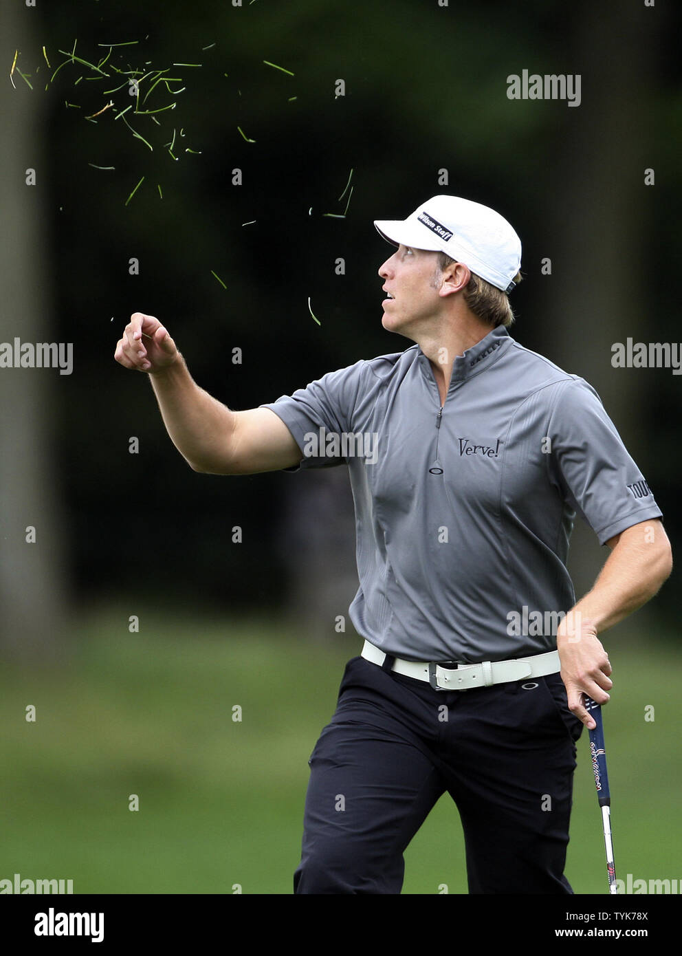 Ricky Barnes throws grass to check the wind on hole 2 in the final ...