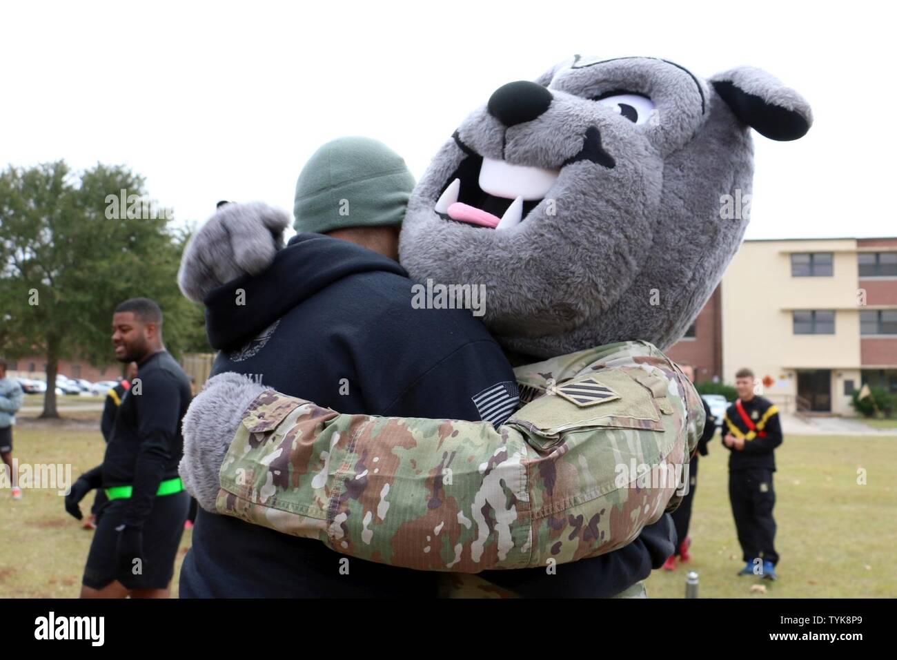 Sgt. Rocky (right), mascot of 3rd Infantry Division, hugs a 3rd ID ...