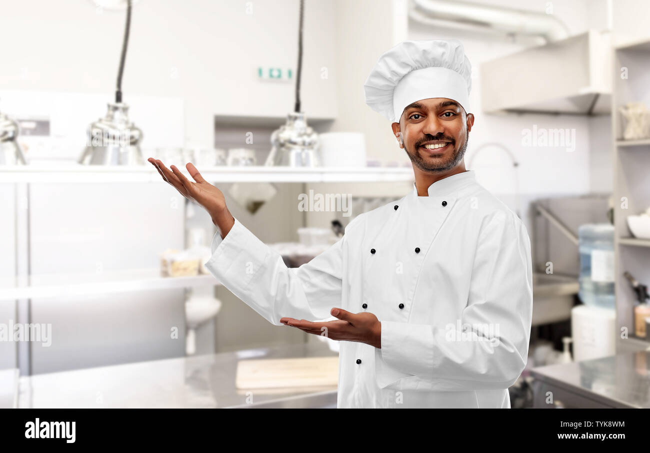 happy male indian chef presents restaurant kitchen Stock Photo - Alamy