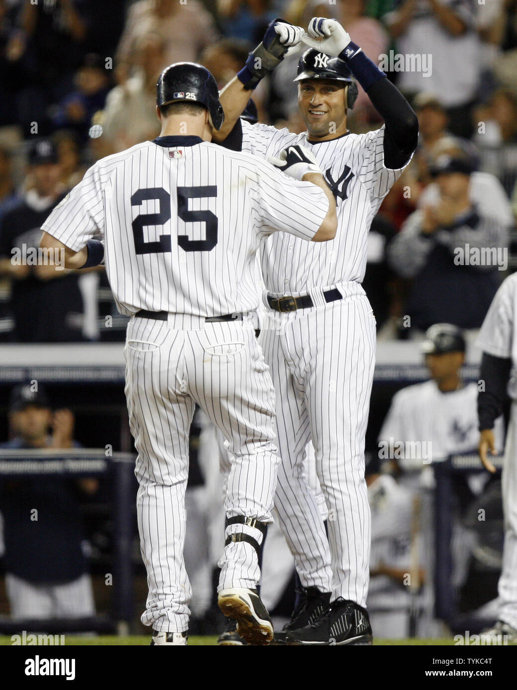 New York Yankees Derek Jeter meets Mark Teixeira (25) at the plate ...