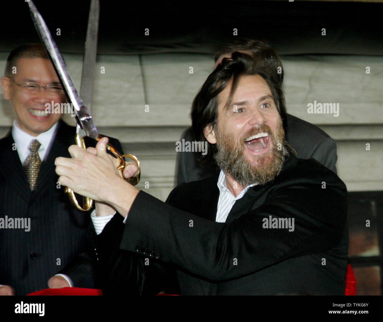 Actor Jim Carrey clowns around with a giant pair of scissors before the ...