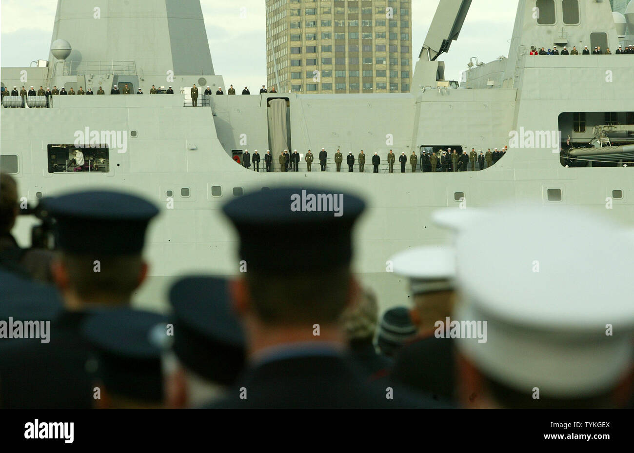 Military personal stand at attention on the deck of the USS New York as ...
