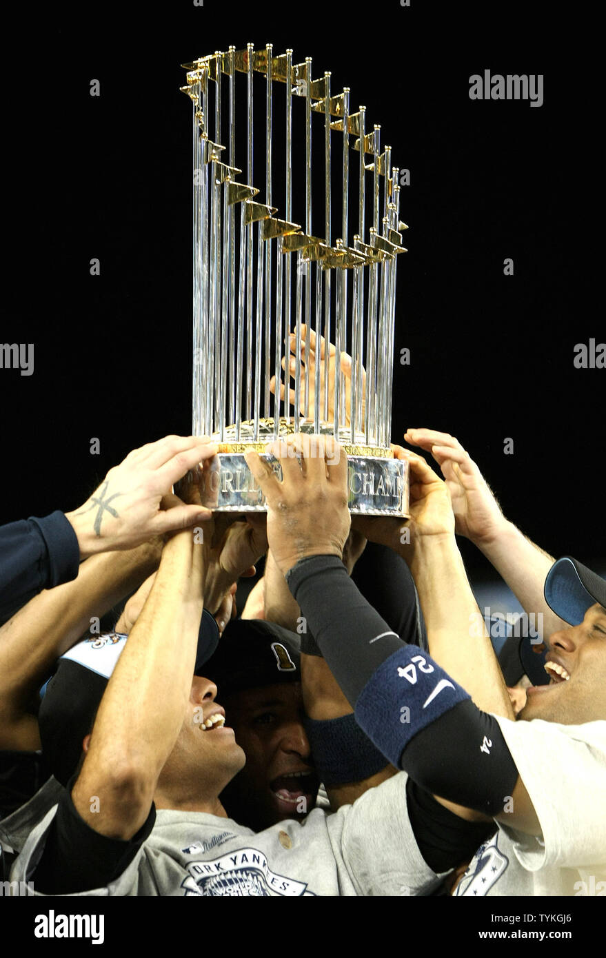 New York Yankees team mates hoist the championship trophy as they ...