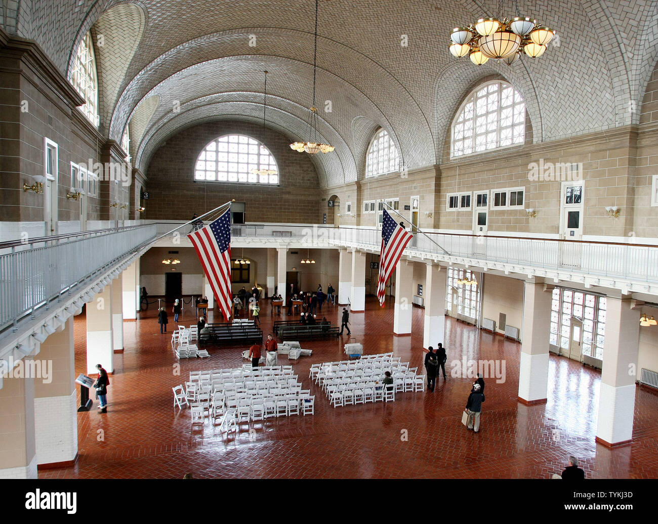 People visit the Great Hall on Ellis Island where immigrants were ...